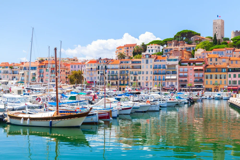 Cannes Beautiful Marina Cannes marina view on a sunny summer day, coastal landscape with moored yachts and colorful houses on a background. France