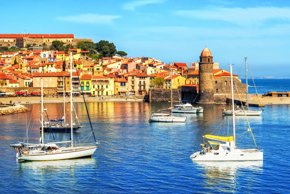 Collioure Seashore Old town of Collioure, France, a popular resort town on Mediterranean sea, view of the habor and church